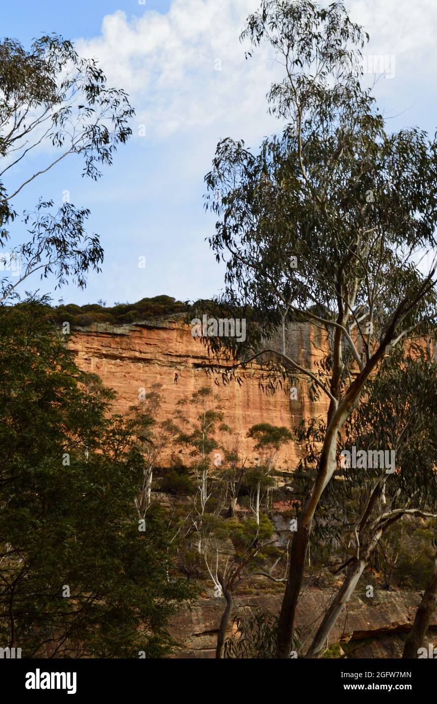 A red cliff face in the afternoon sun Stock Photo - Alamy