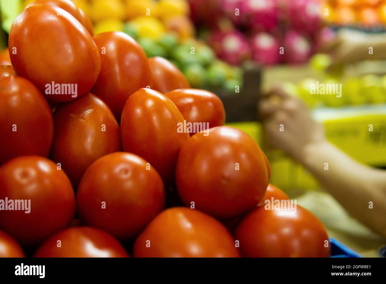 Stack of tomatoes on display at a traditional food market. In th Stock ...