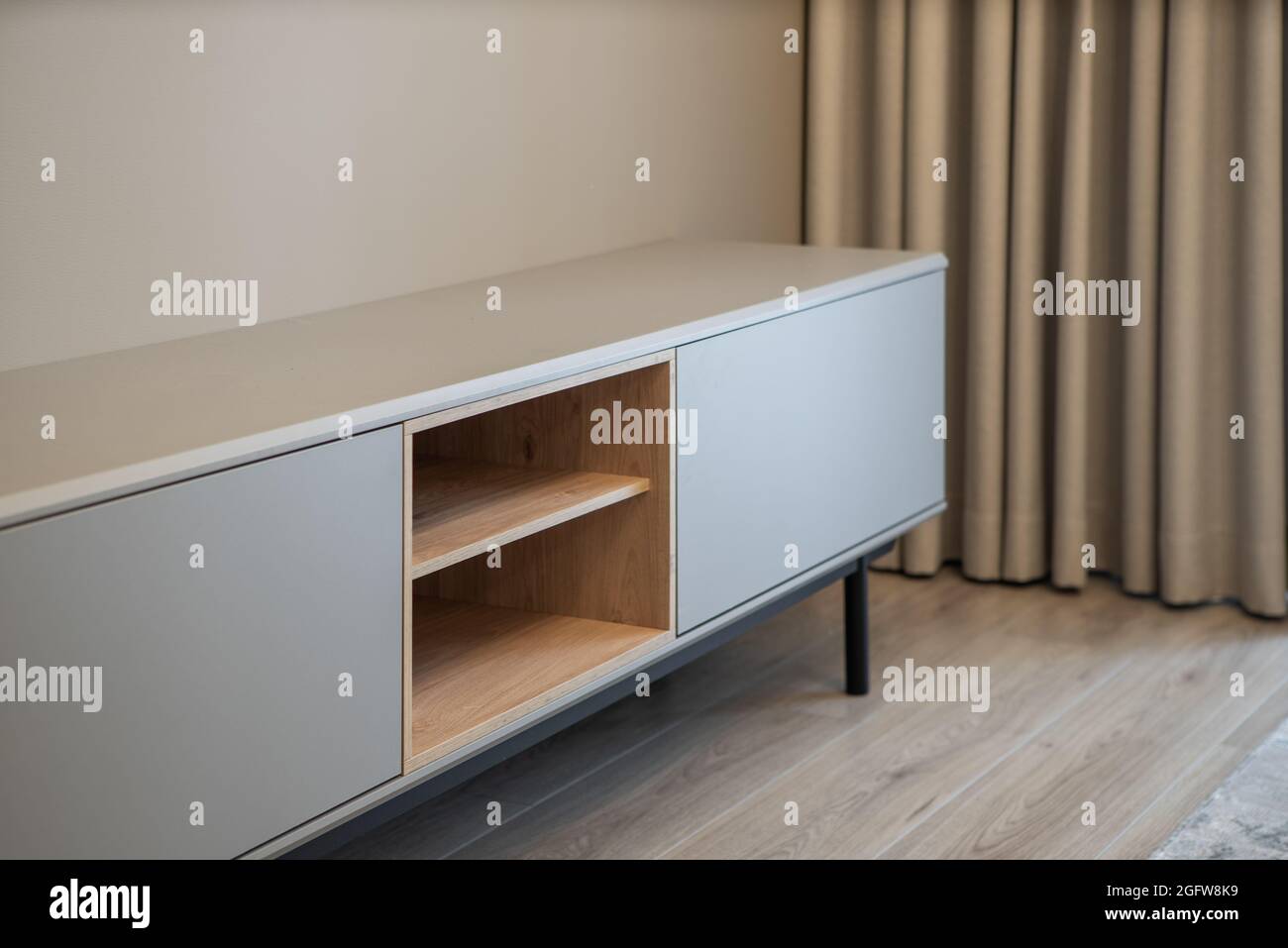 Close-up of new empty wooden tv stand. Modern interior of living room ...