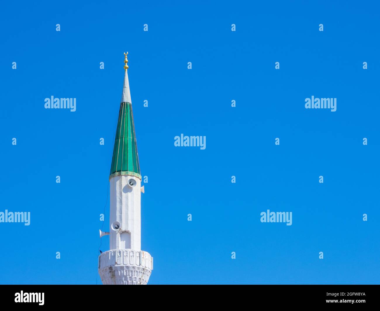 ALANYA, TURKEY - 26th MAY, 2021. Minaret of a mosque with a green dome ...
