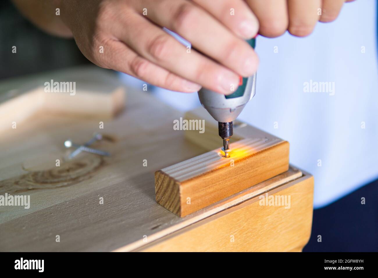 Close up view of a man's hands using an electric screwdriver to Stock ...