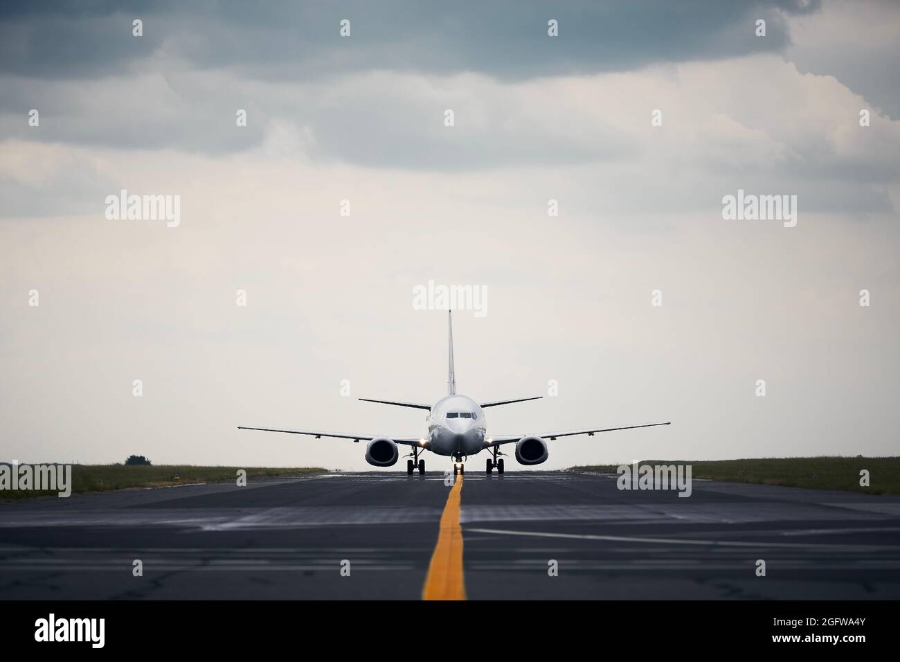 Front view of plane at airport. Commercial airplane during taxiing to ...