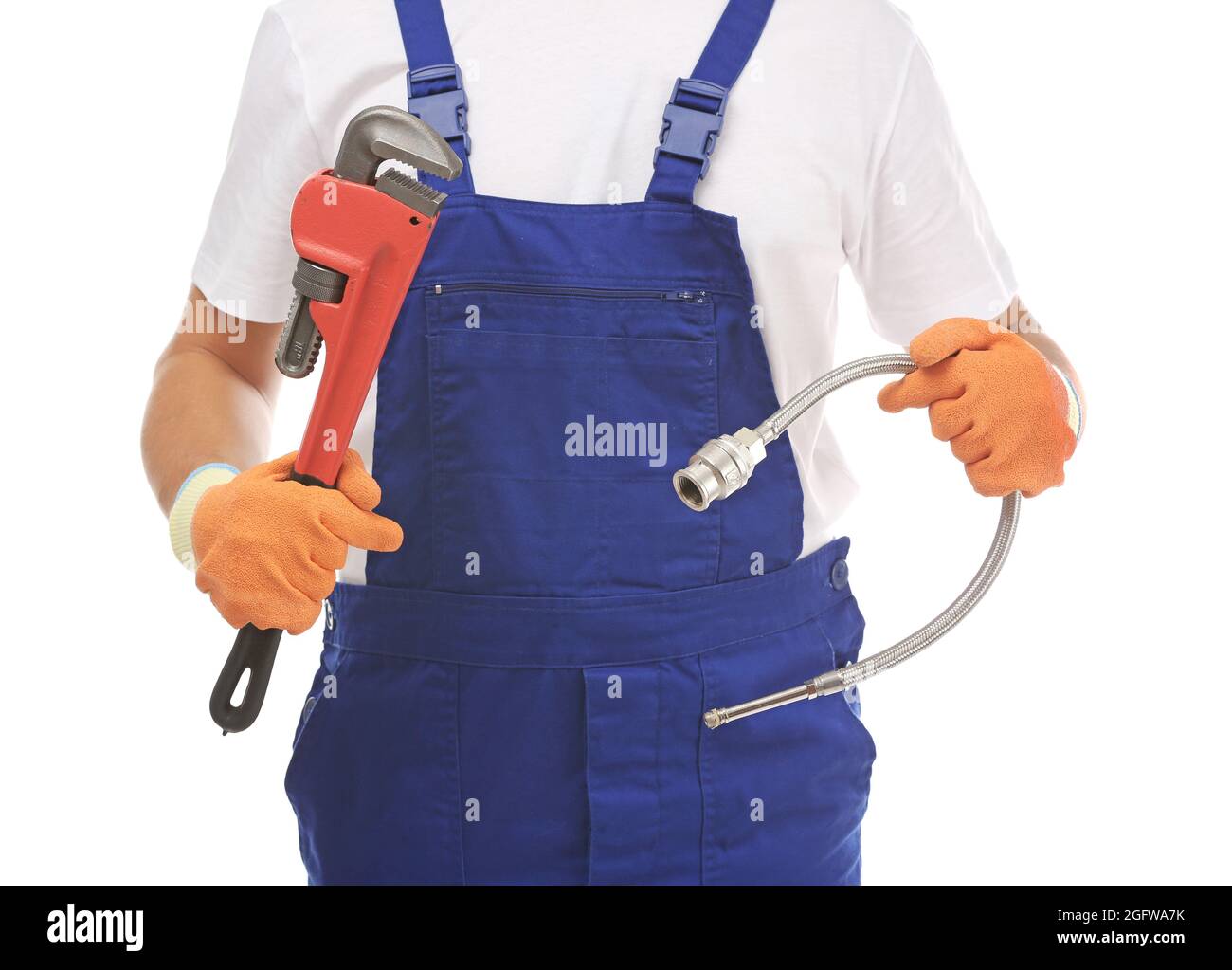 Young handsome plumber with pipe wrench and flexible hose on white ...