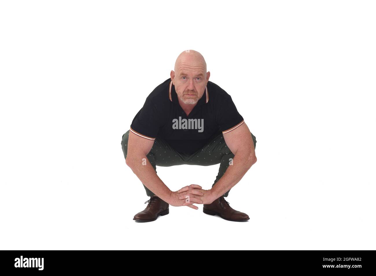 front view of a man squatting on white background Stock Photo - Alamy