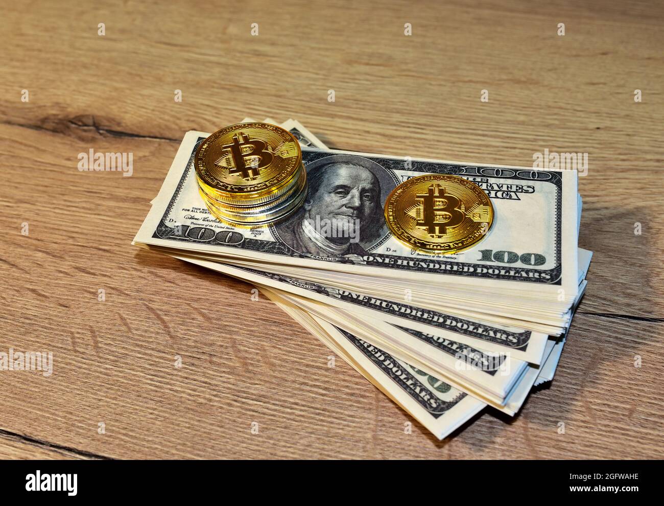Bitcoin coins on a bundle with dollars. The concept of investing money ...