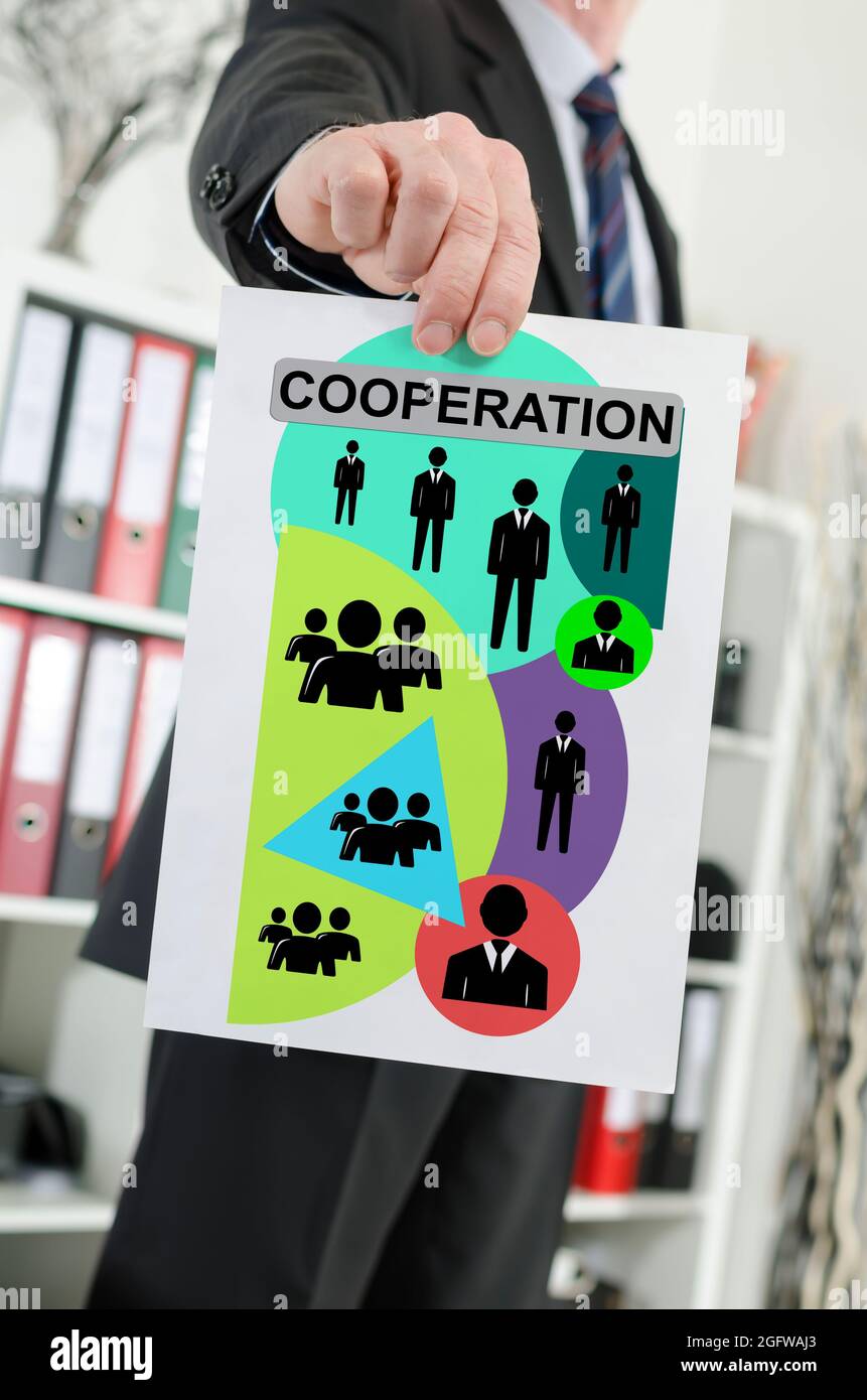 Paper showing cooperation concept held by a businessman Stock Photo - Alamy