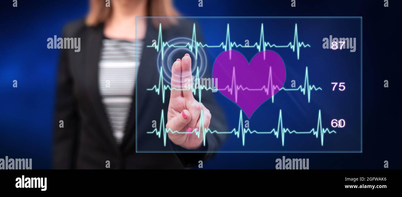Woman touching a heart beats graph concept on a touch screen with her ...