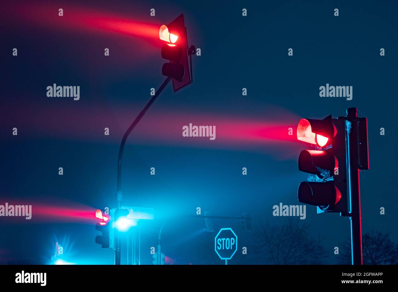 Streetlights glowing red in the dark foggy street Stock Photo - Alamy