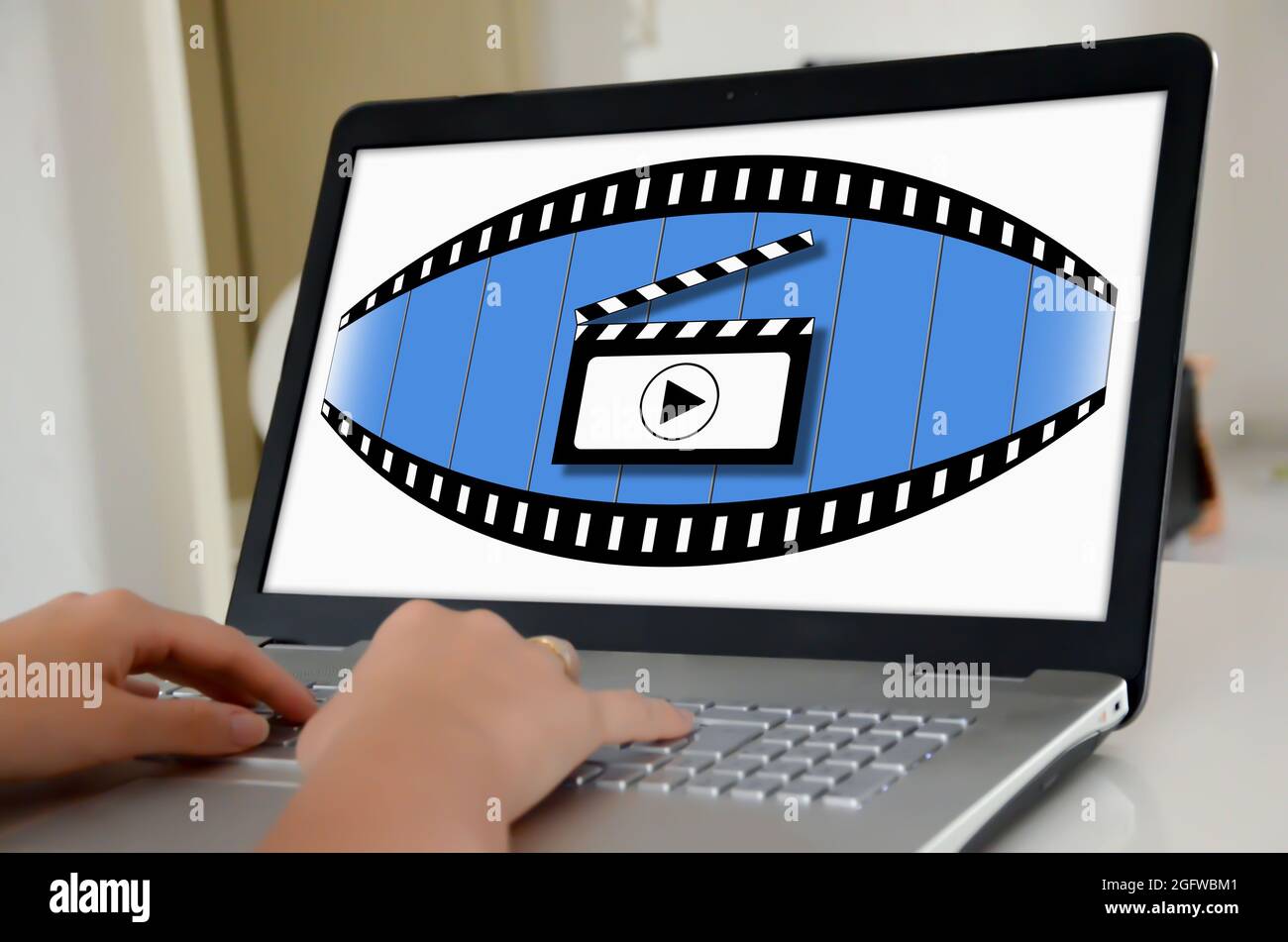 Hands on a laptop with screen showing cinema concept Stock Photo - Alamy