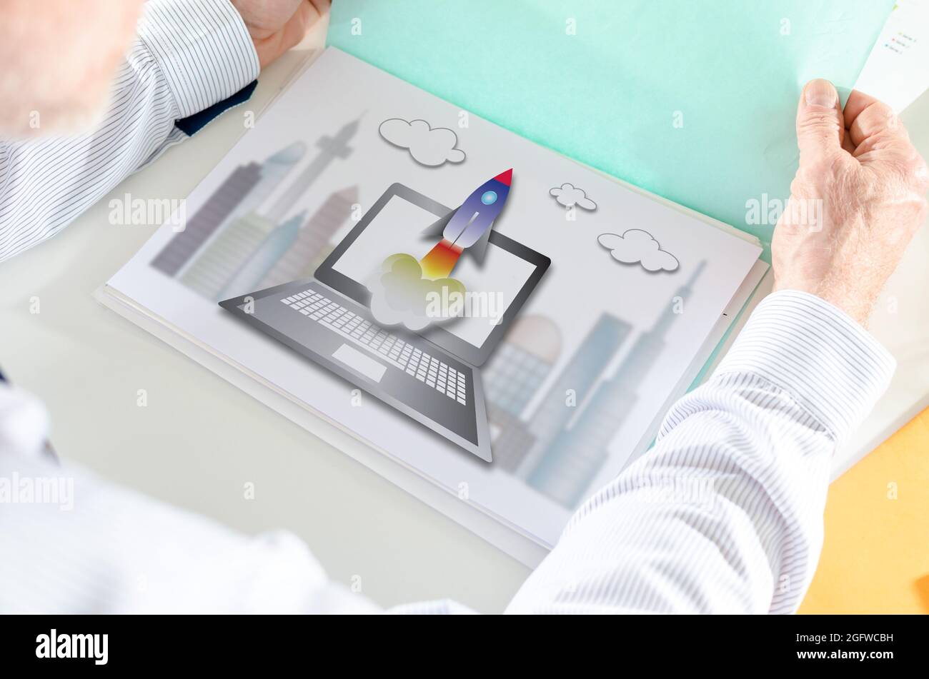Man holding a file with startup concept Stock Photo - Alamy