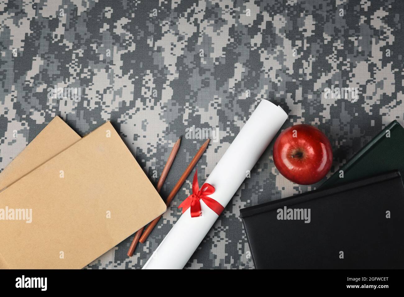 Military education concept. Books, pencils, scroll paper and apple on ...
