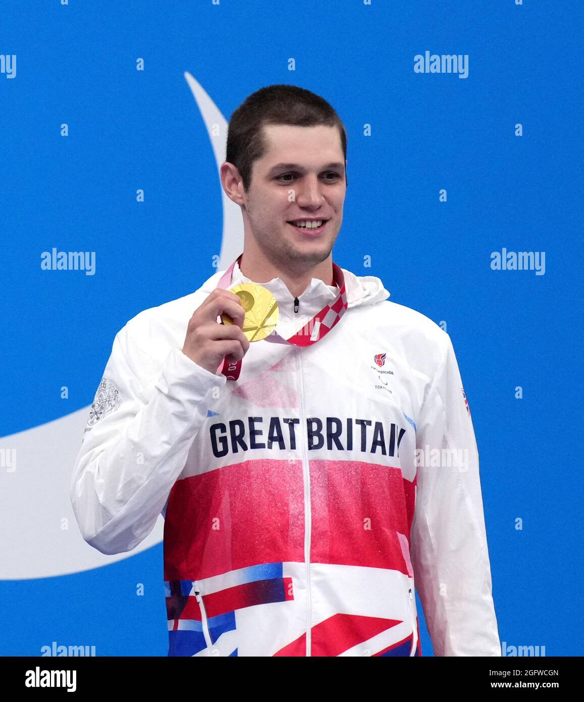 Great Britain's Reece Dunn poses with his gold medal on the podium ...