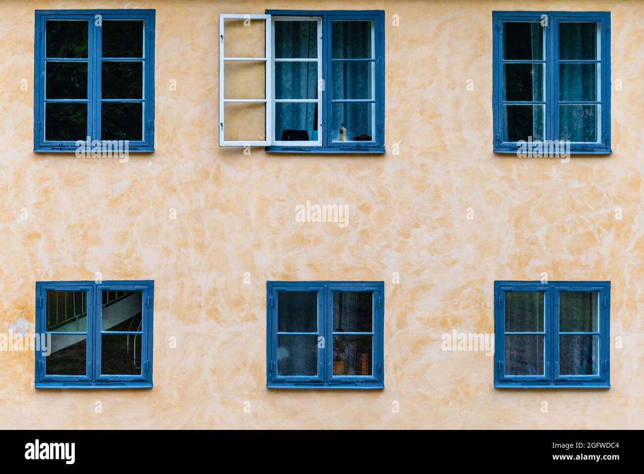 Six wooden blue painted windows on plaster wall. Architectural ...