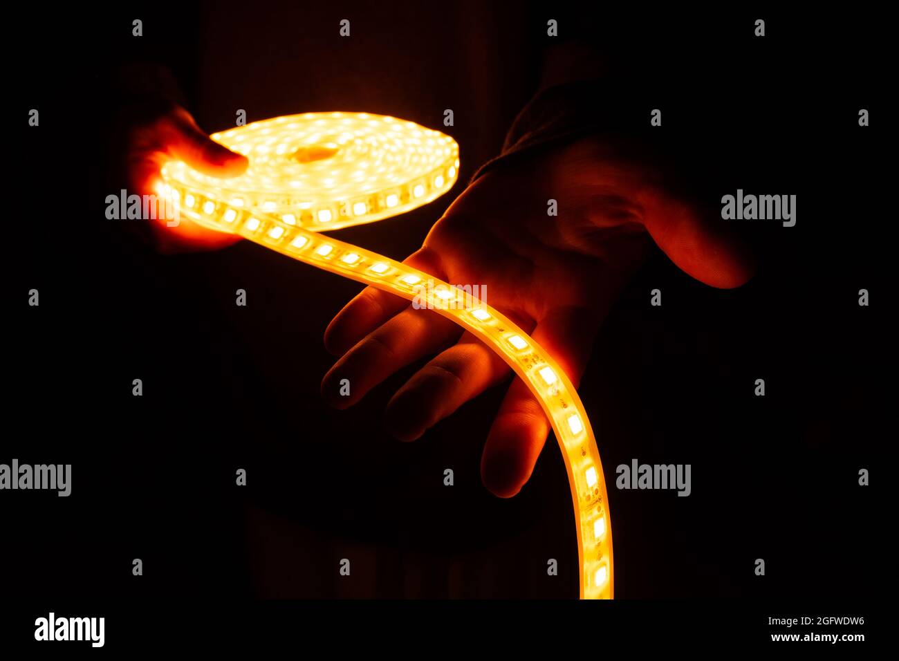decorative soft led light, diode lighting logo in hand Stock Photo - Alamy