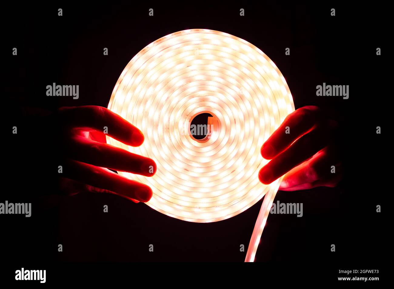 LED Strip Light, red coil diode lighting in hand Stock Photo - Alamy