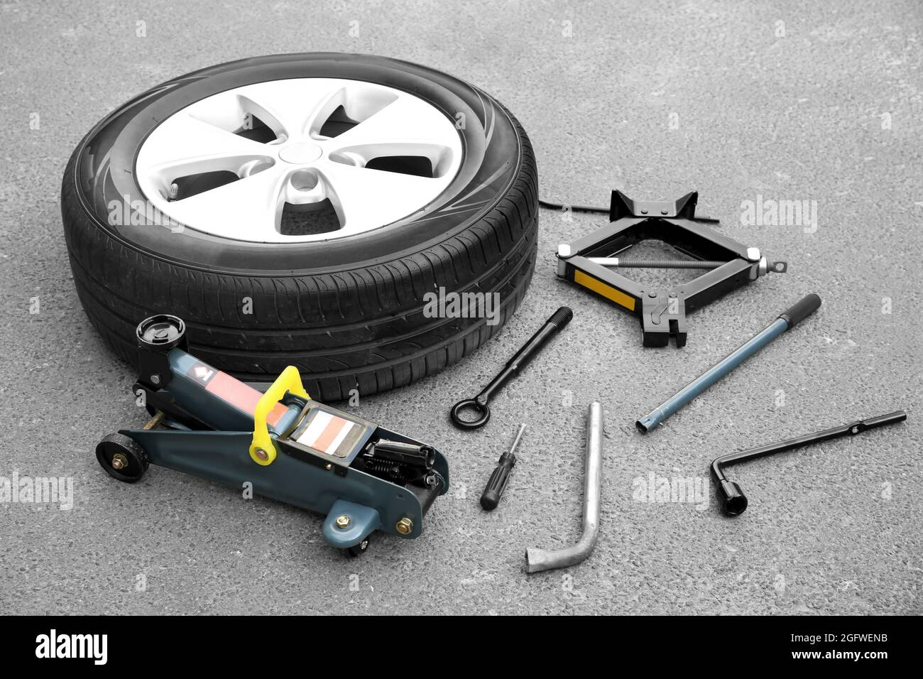 Car wheel with tools on asphalt background Stock Photo - Alamy
