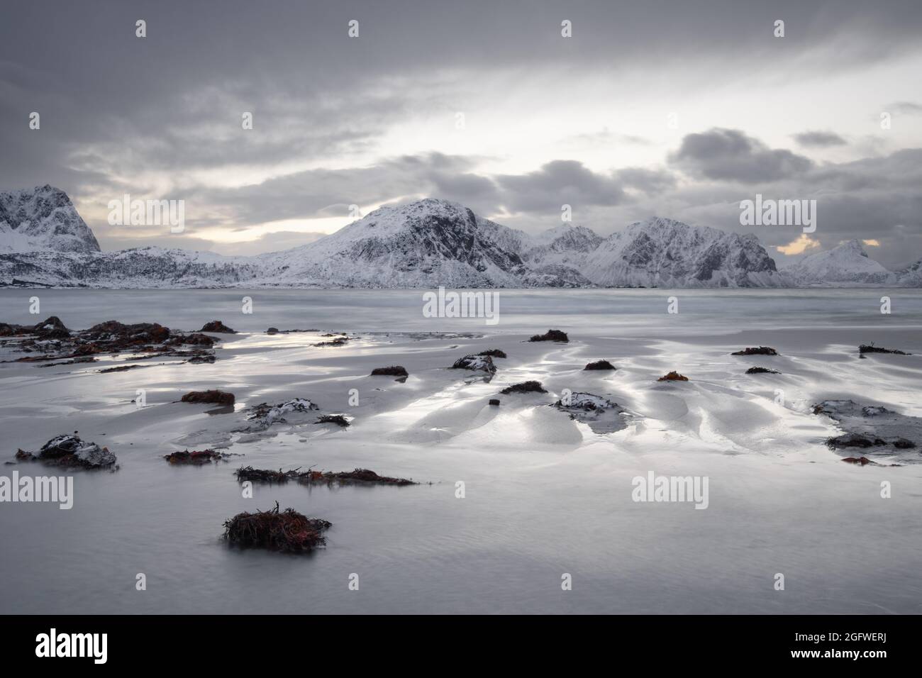 Coastal landscape in winter after sunset, sandy beach with small ...