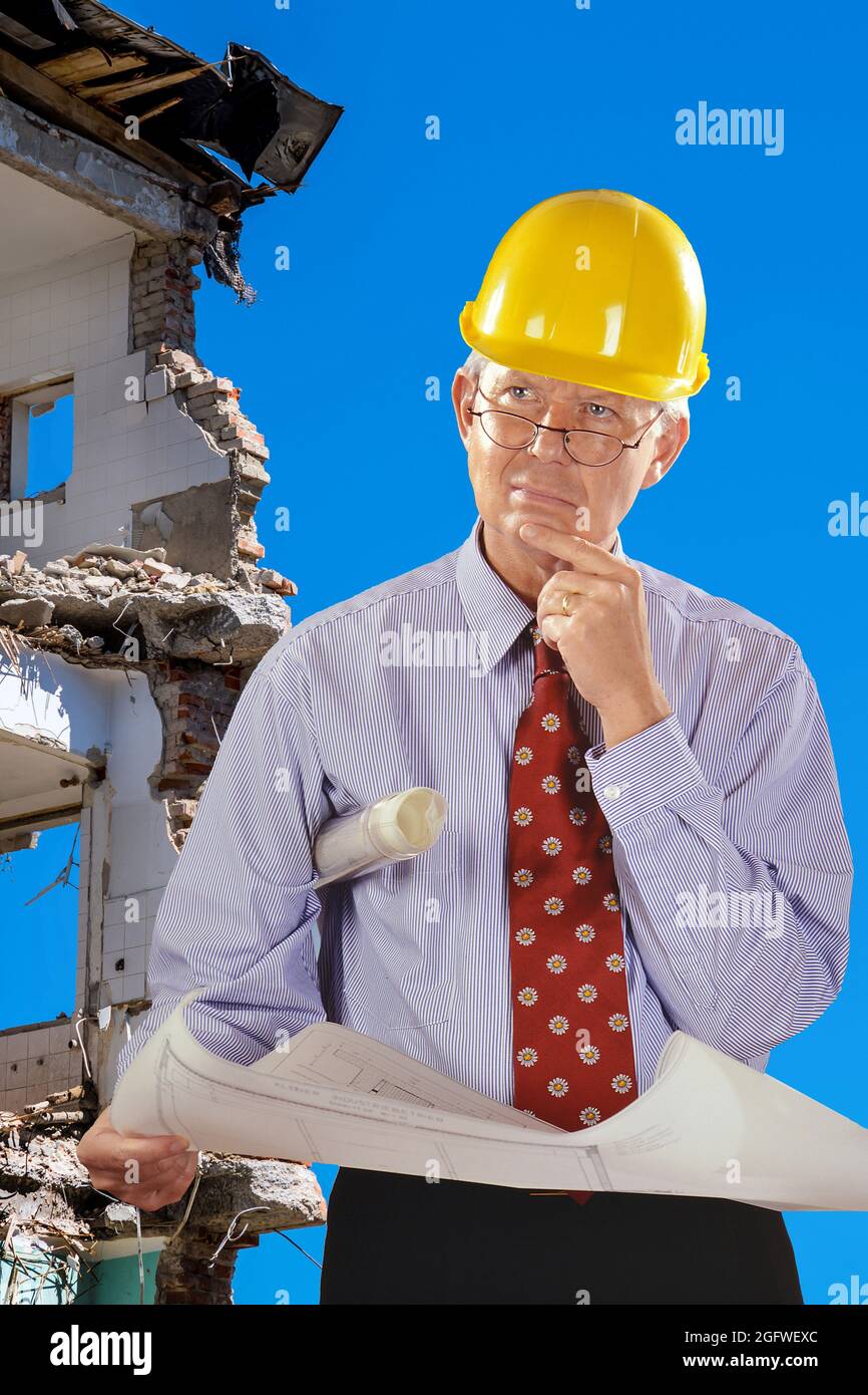 architect with construction plan and hard hat, building demolition in ...