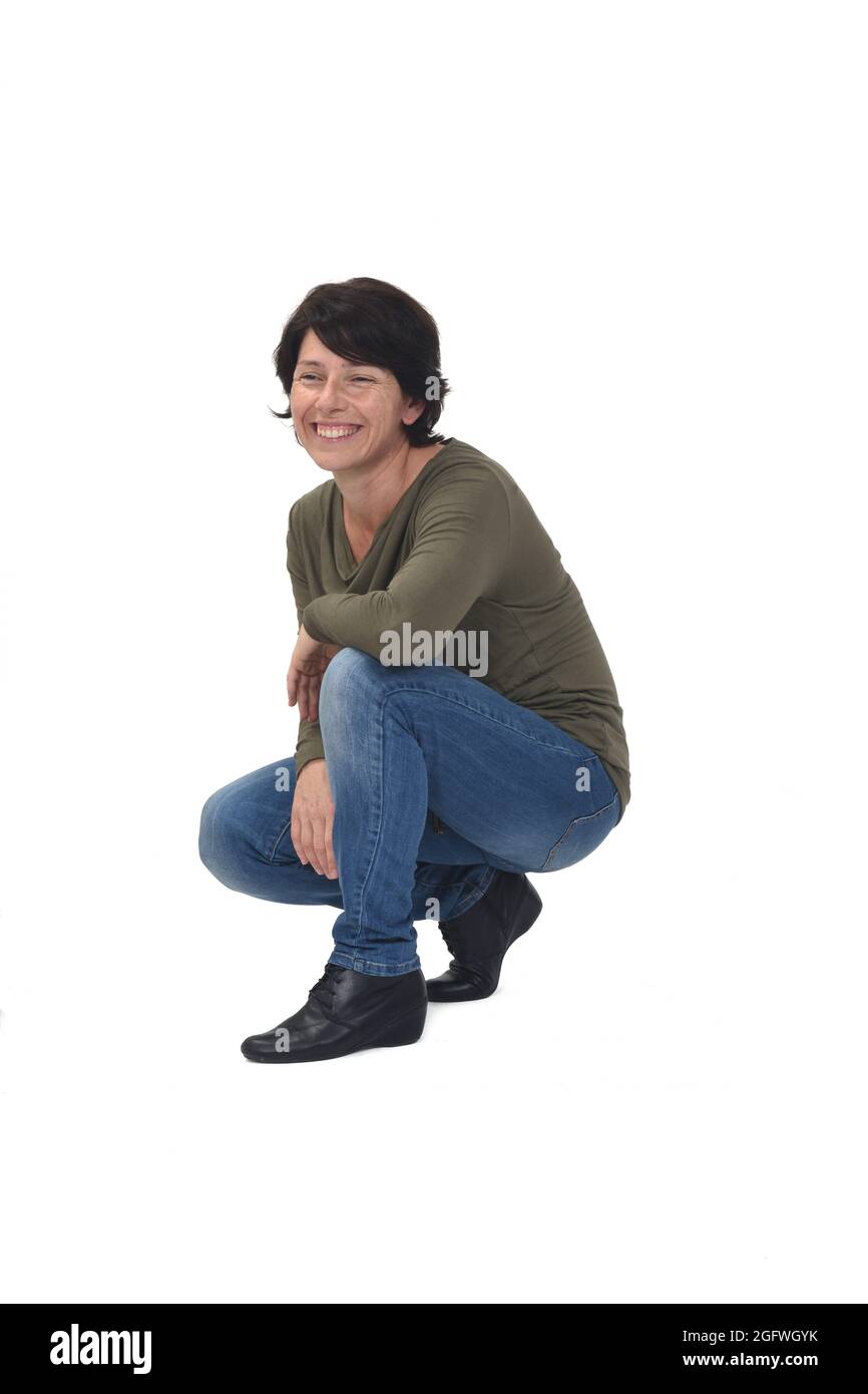 Pretty woman crouching on floor Cut Out Stock Images & Pictures - Alamy