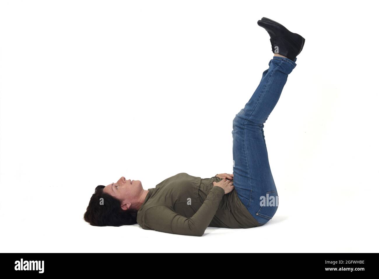 woman sitting on the floor and legs up on white background Stock Photo ...