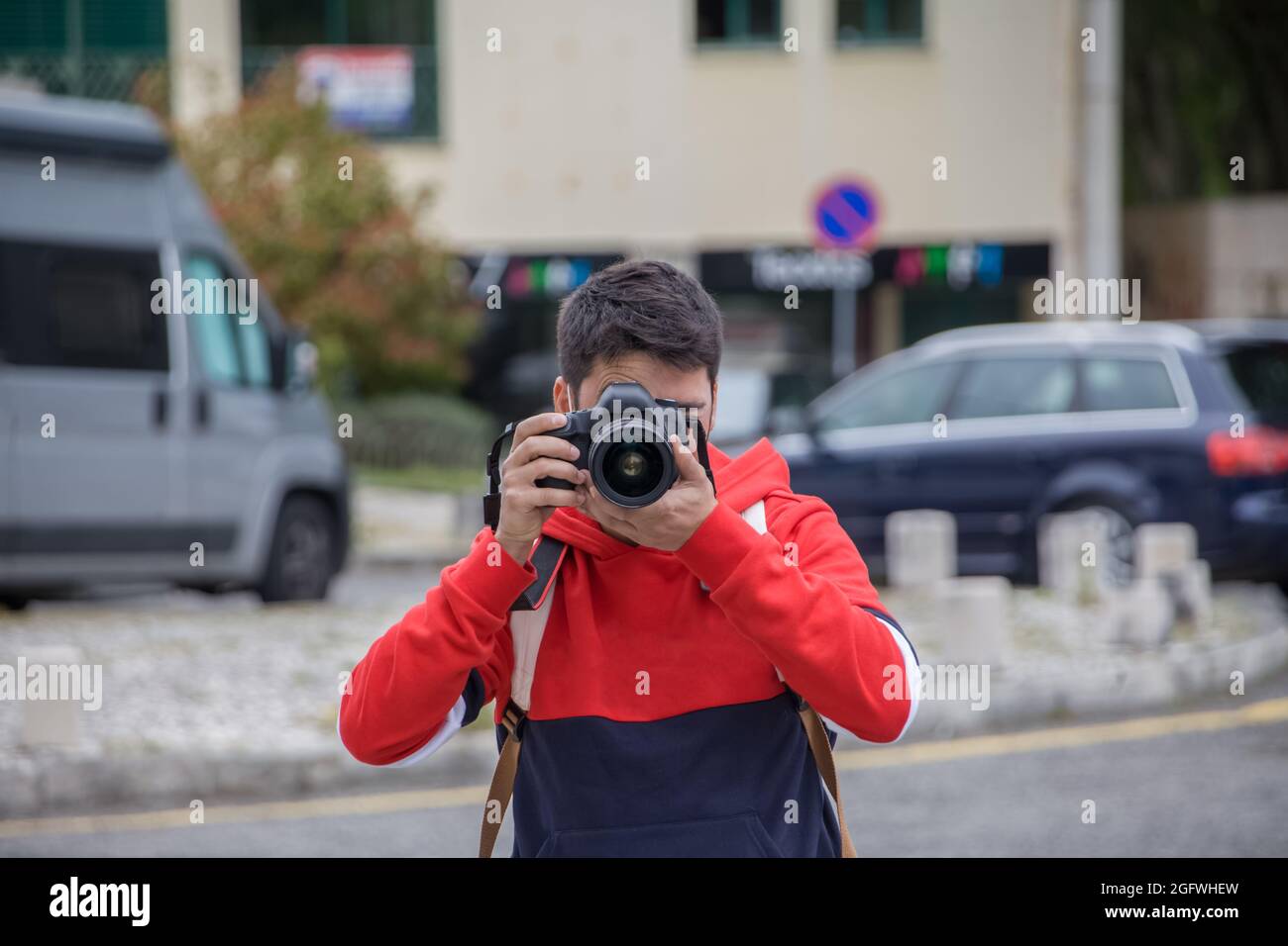 Half-body view of a professional photographer taking a photograph in ...