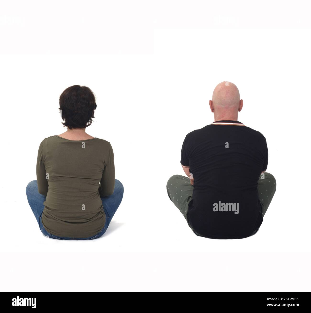 rear view of a woman and man sitting on the floor isolated on white ...