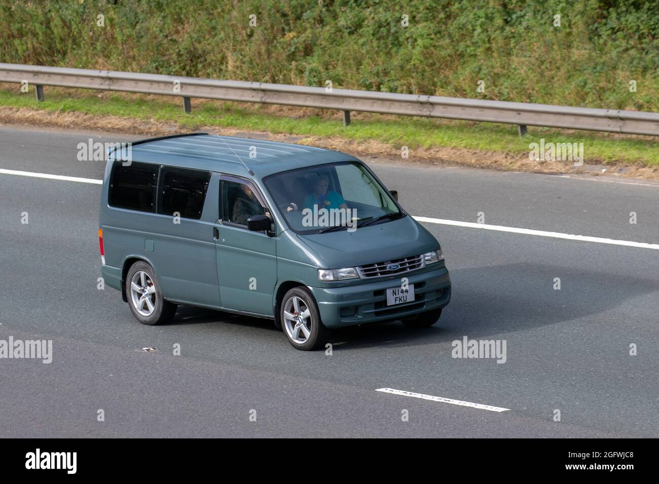 1996 90s green Ford window van driving on the M6 Motorway UK Stock ...