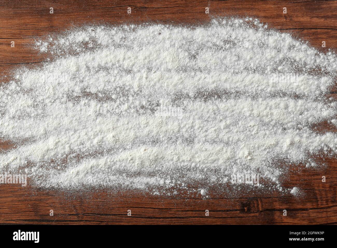 White flour on wooden kitchen table Stock Photo - Alamy