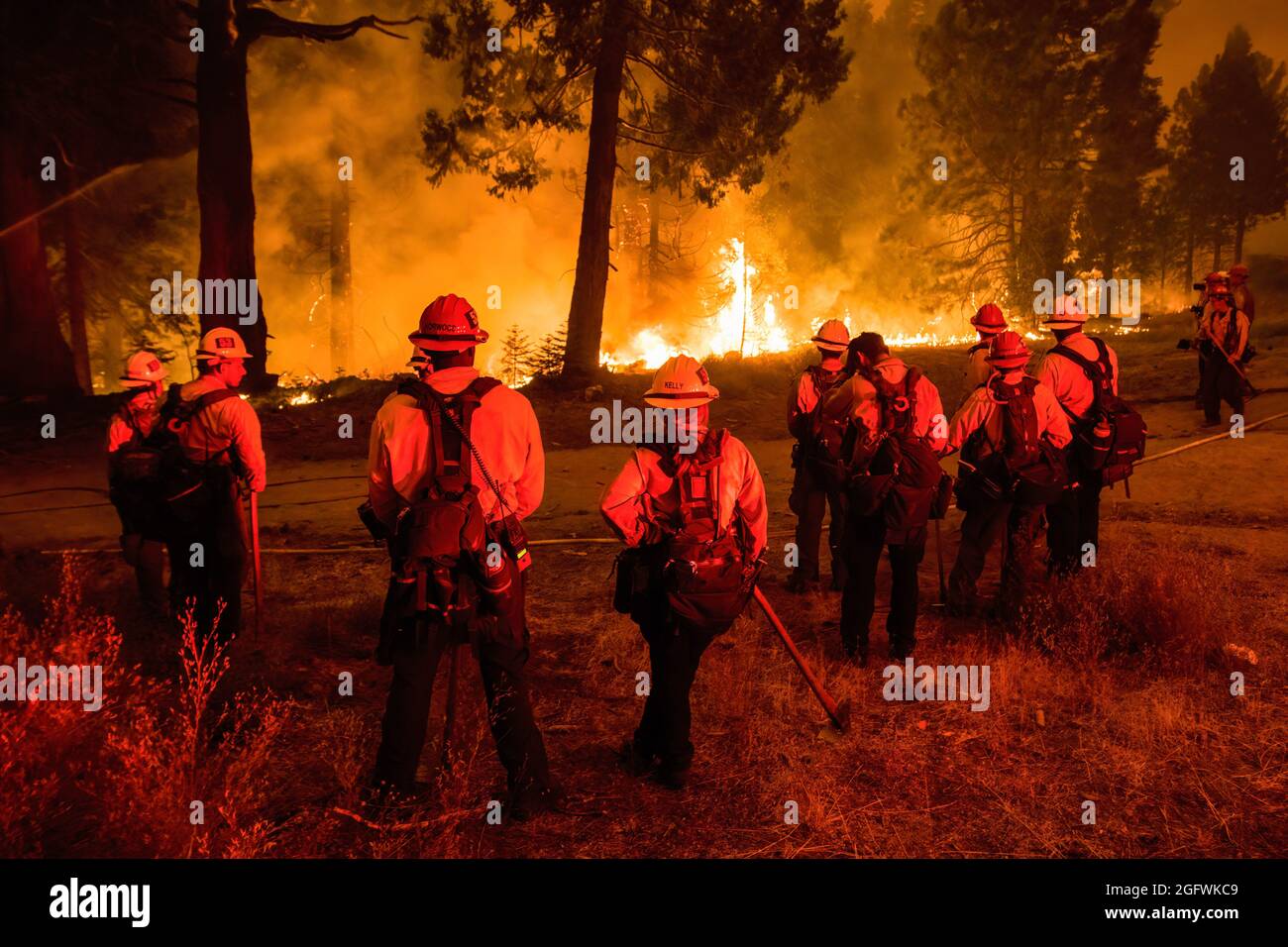 Firefighters stand by flames at the Caldor fire after starting a ...