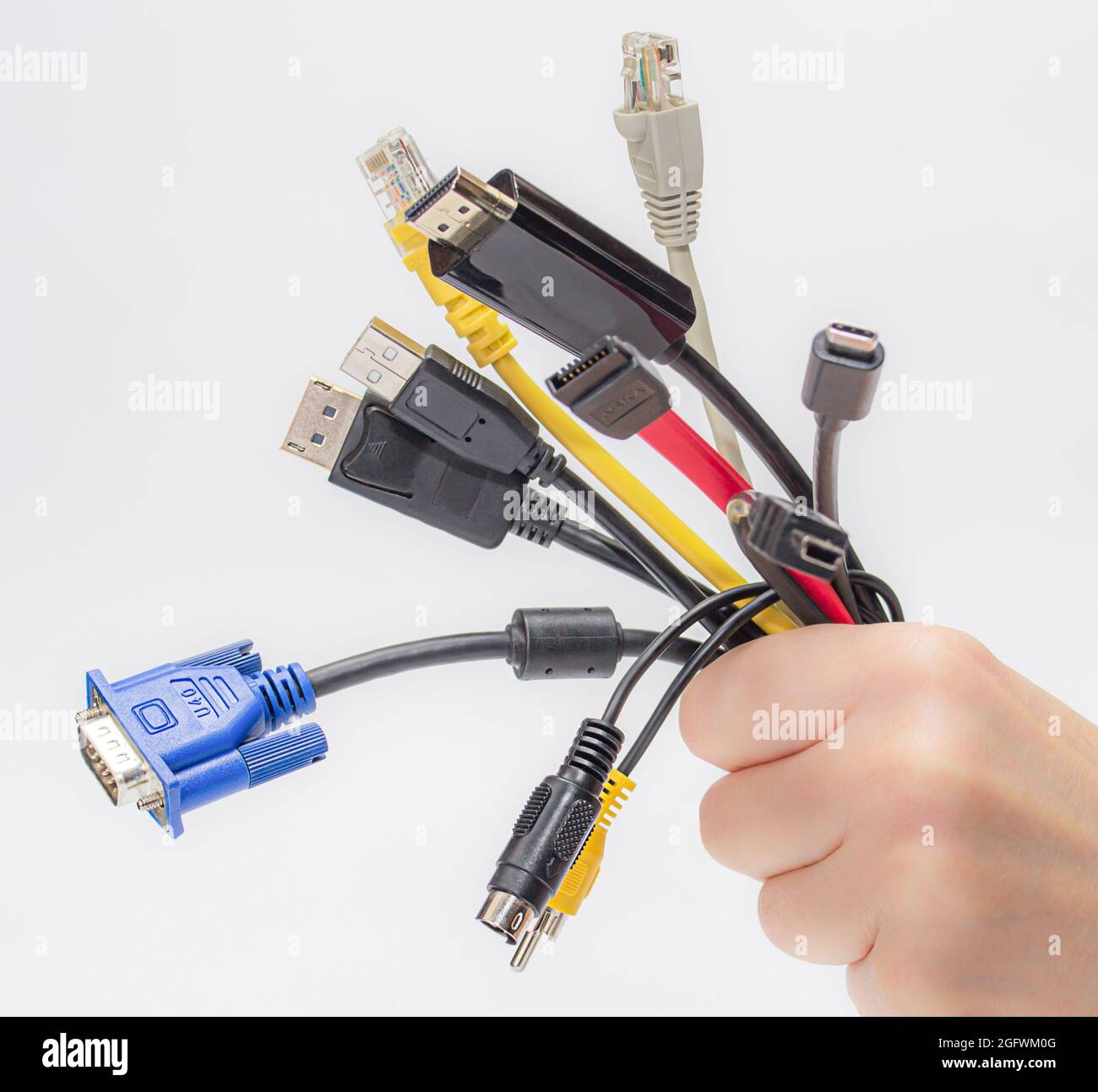 cables in hand isolated on white background. bundle of computer ...