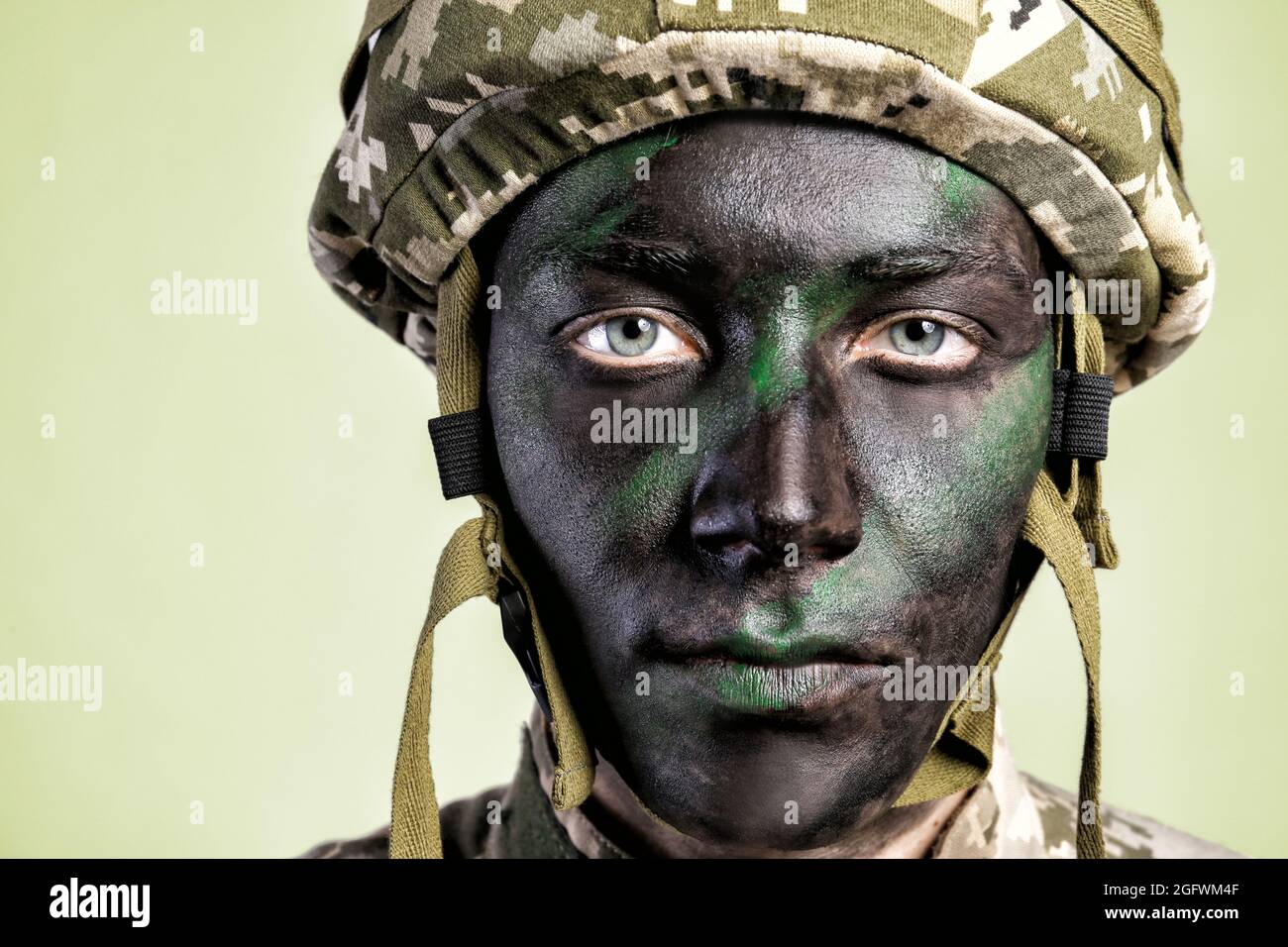 Portrait of soldier with painted face on grey background, close up view ...