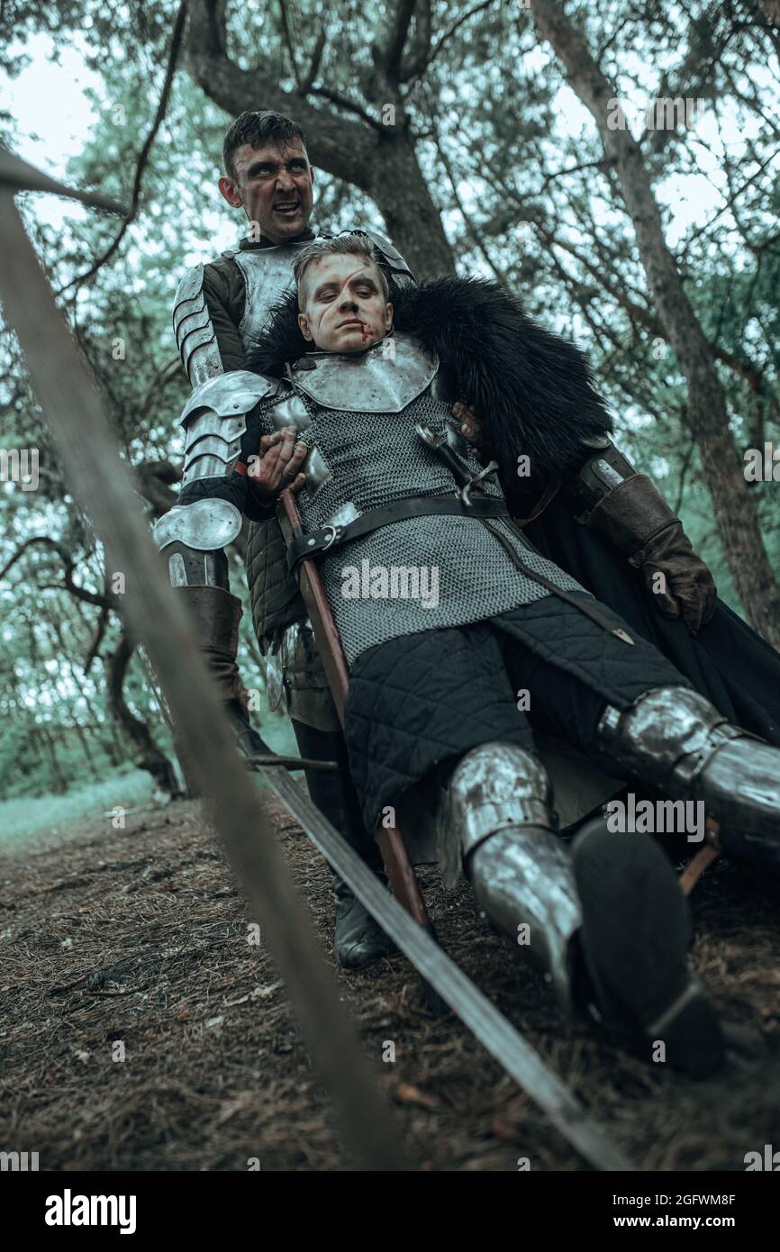 Medieval knight in chain mail armour drags on the ground warrior ...