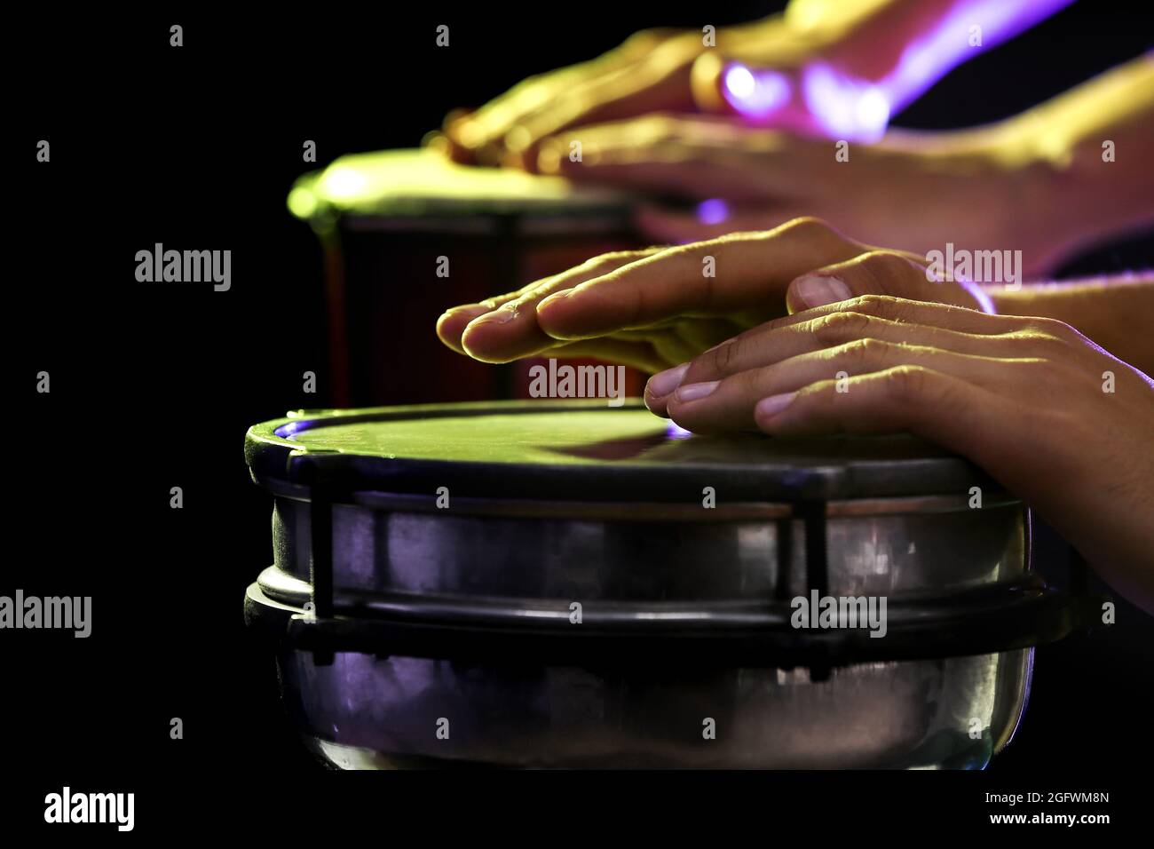 Hands of man playing African drum on dark background Stock Photo - Alamy