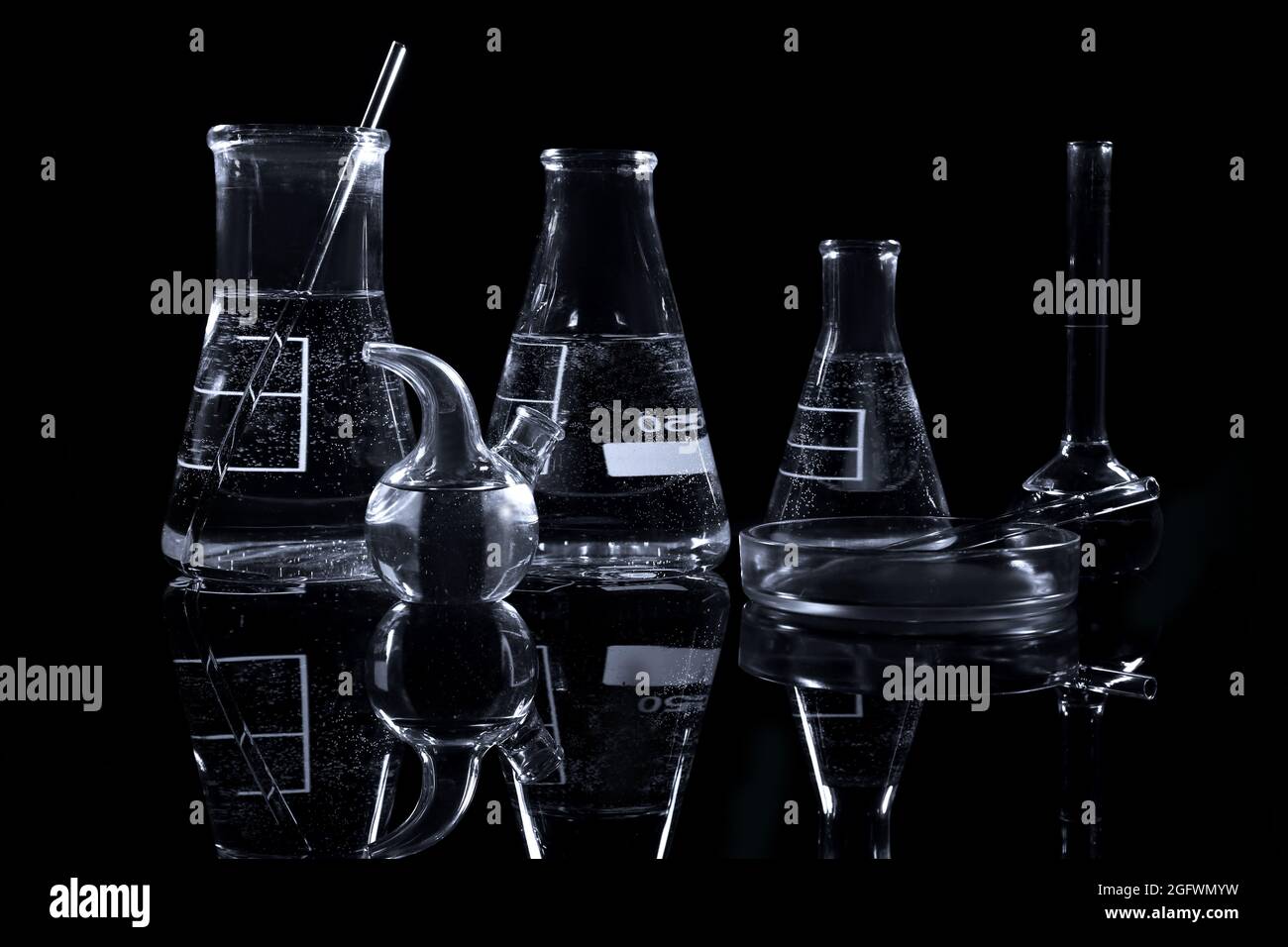Test beakers and flasks on dark background Stock Photo - Alamy