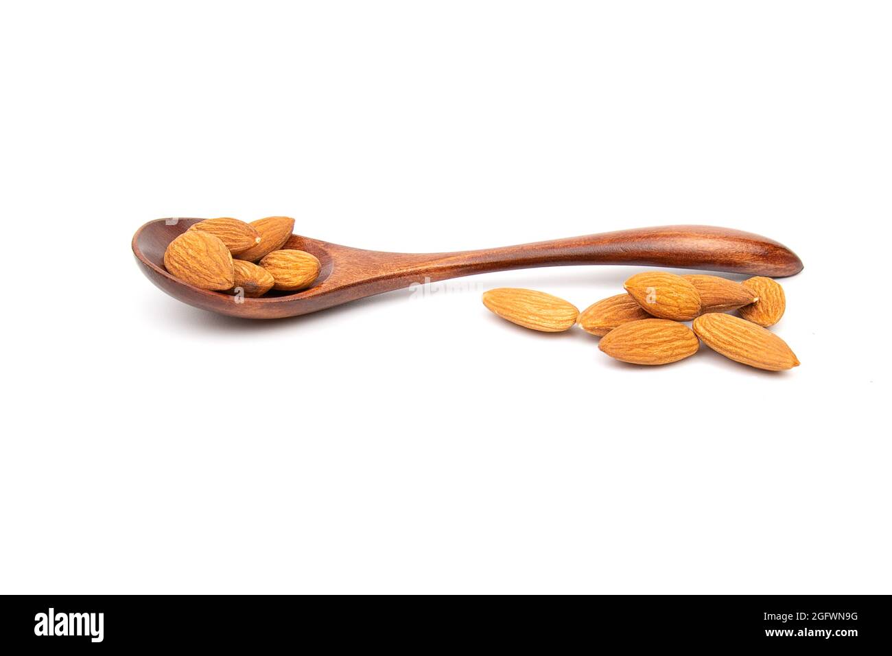 Nuts almonds in a wooden spoon on a white background Stock Photo - Alamy