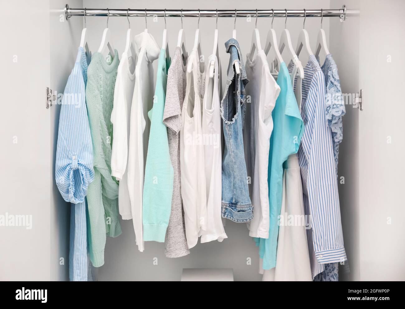 Collection of clothes hanging on a rack Stock Photo - Alamy
