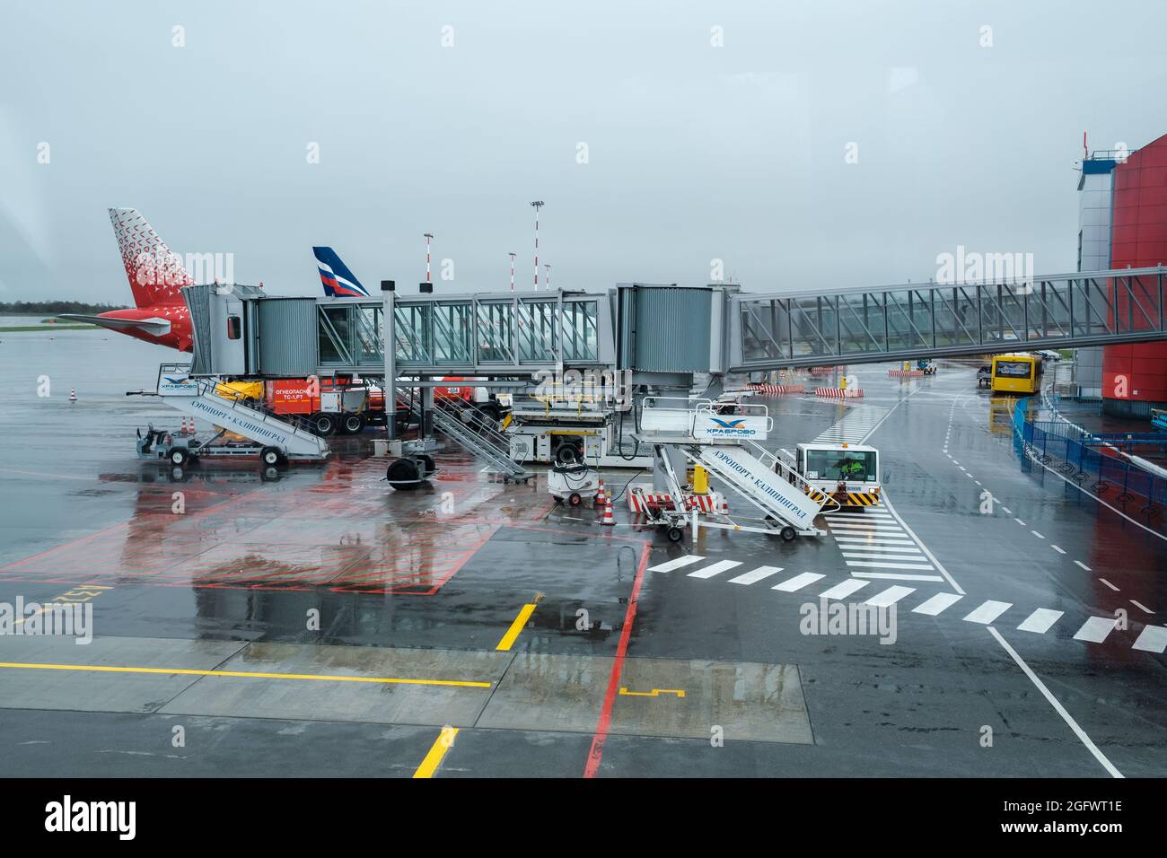 Jet bridge and plane on aerodrome Stock Photo - Alamy