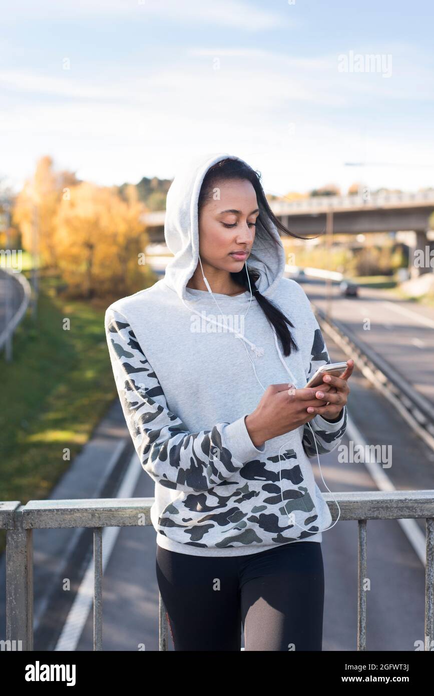 Young woman checking cell phone Stock Photo - Alamy
