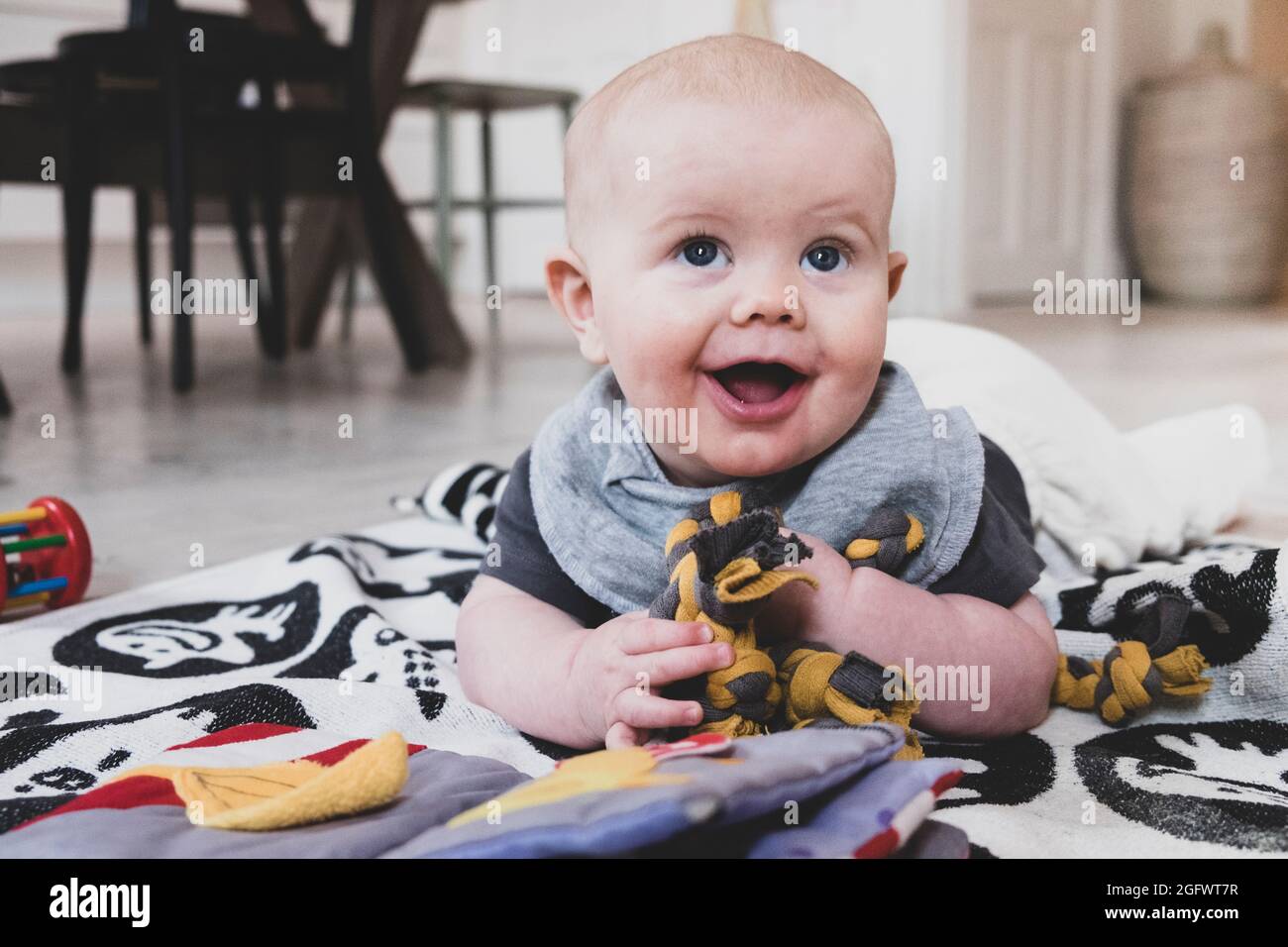 Happy baby looking away Stock Photo - Alamy
