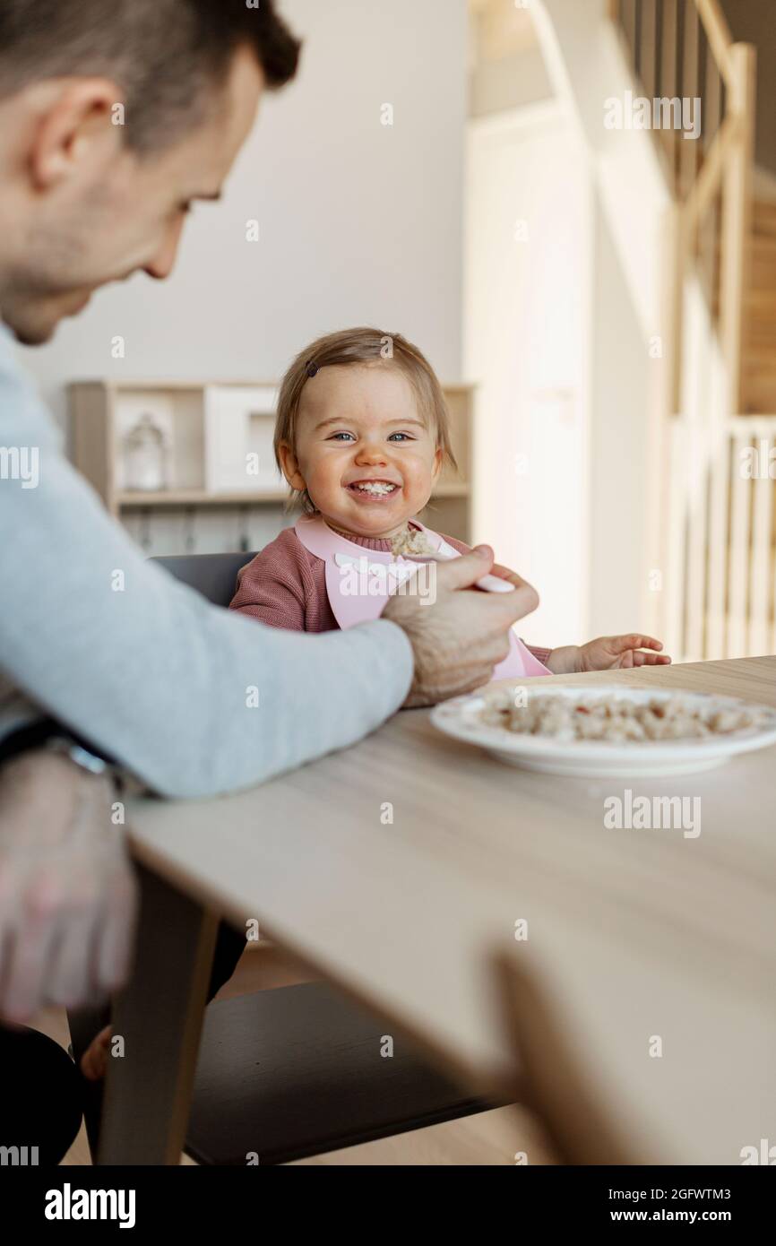Father feeding toddler daughter Stock Photo - Alamy