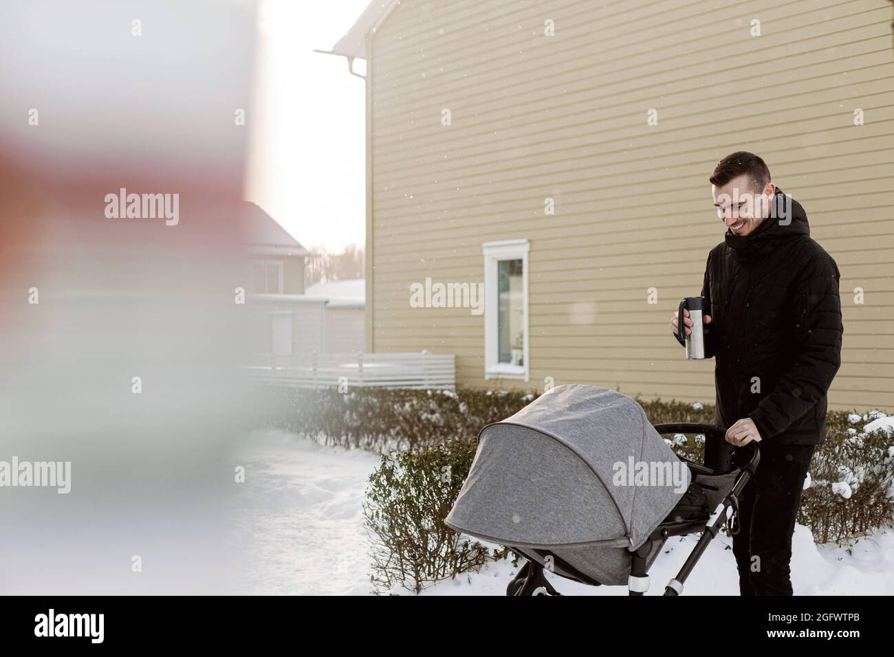 Smiling man pushing pram at walk Stock Photo - Alamy