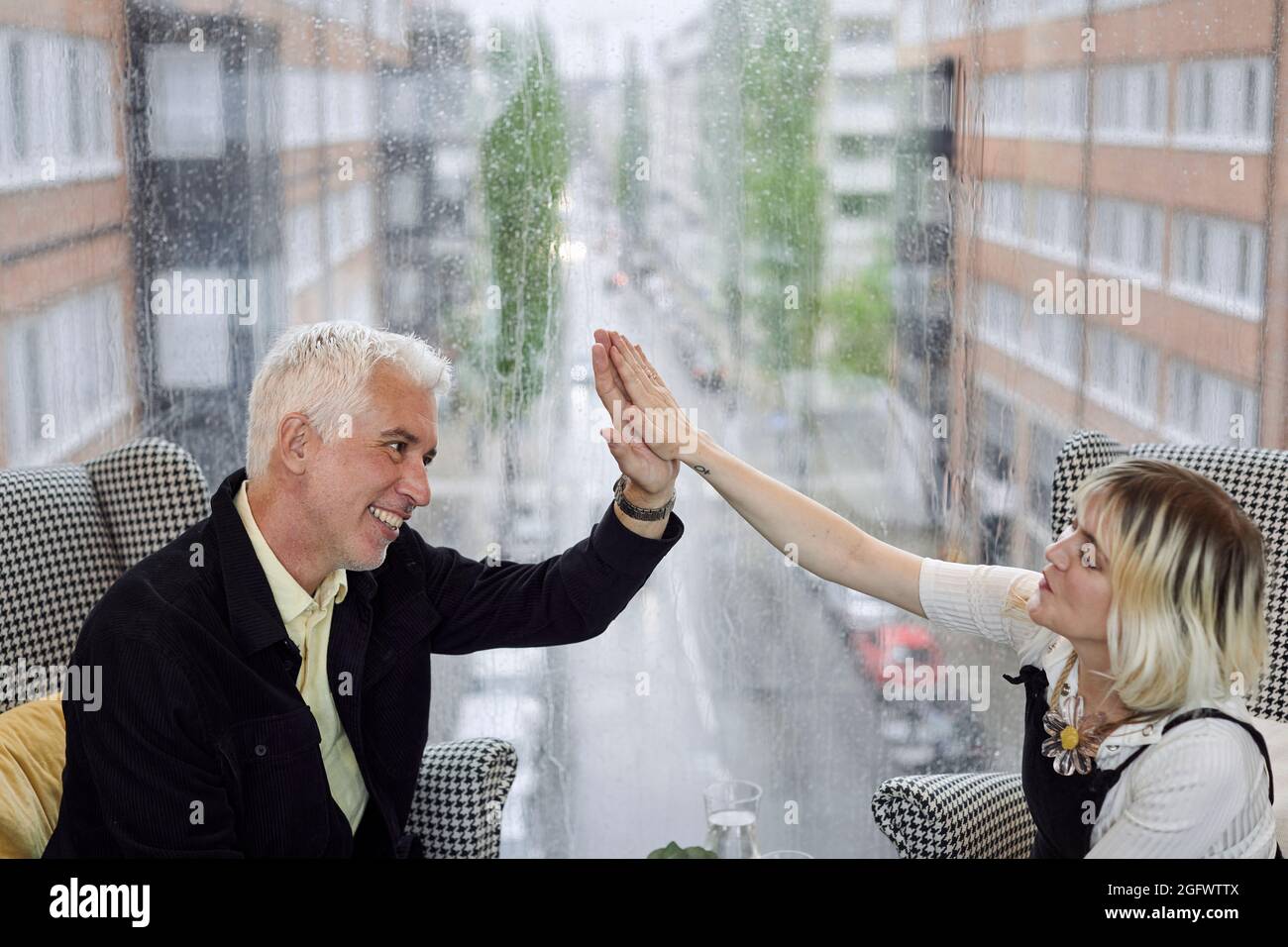 Coworkers high fiving Stock Photo - Alamy
