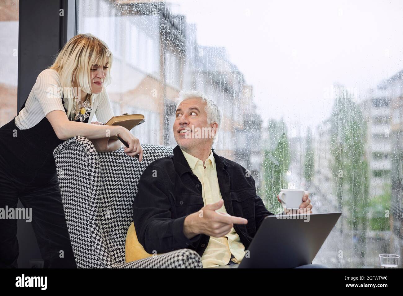 Coworkers talking at work Stock Photo - Alamy