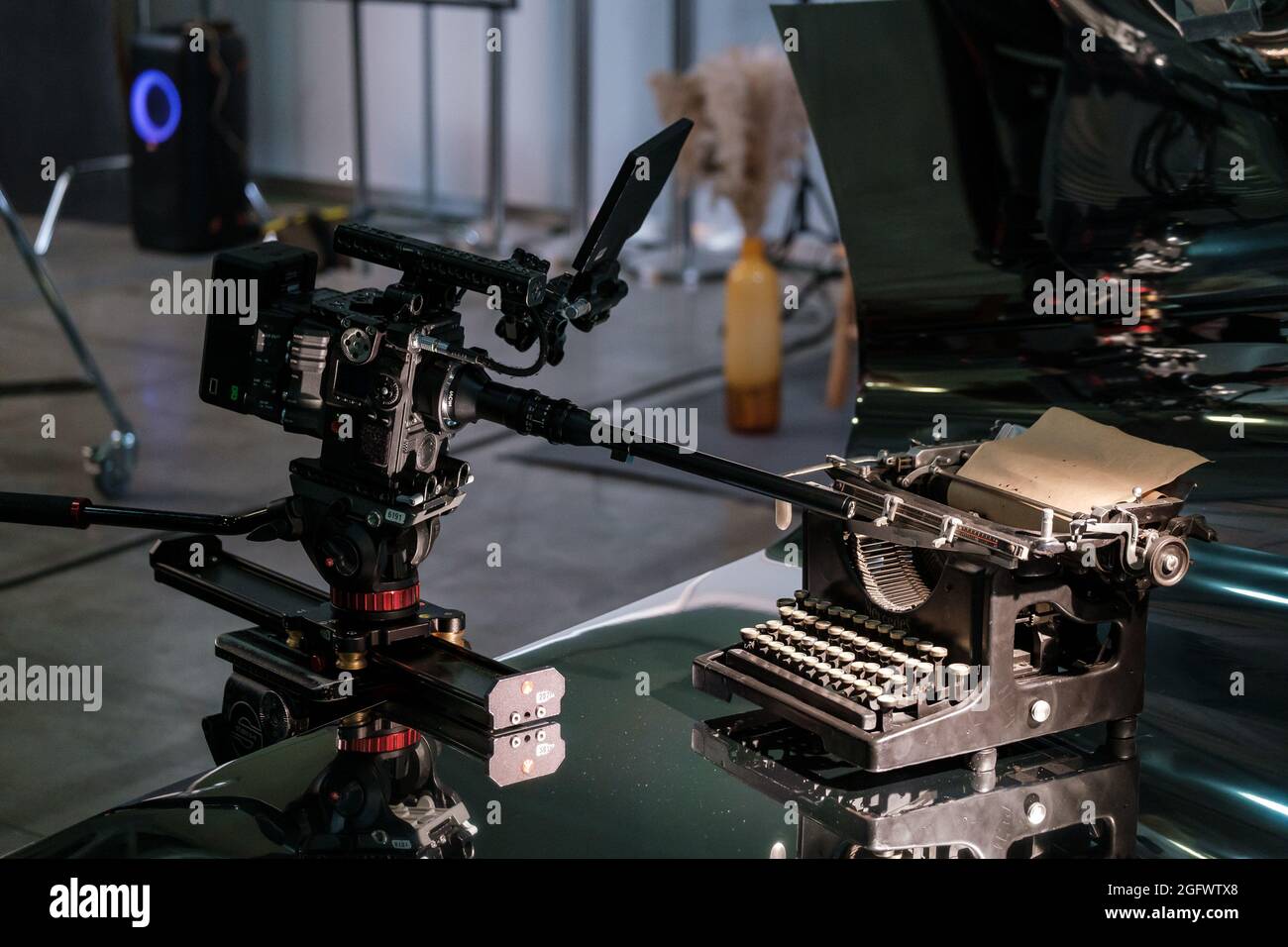Modern camera shooting retro typewriter Stock Photo - Alamy