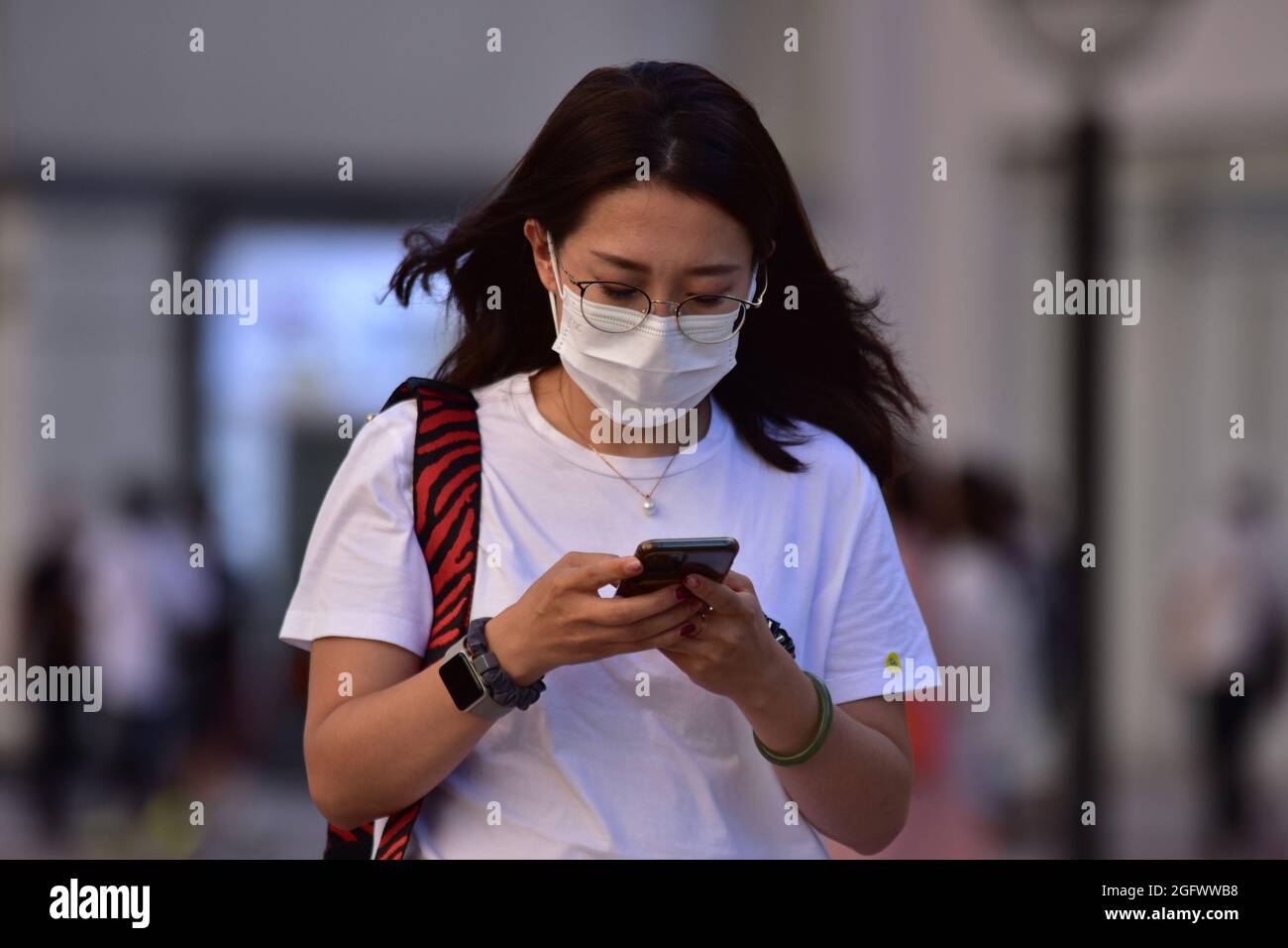 BEIJING, CHINA - AUGUST 27, 2021 - People use smartphones at the ...