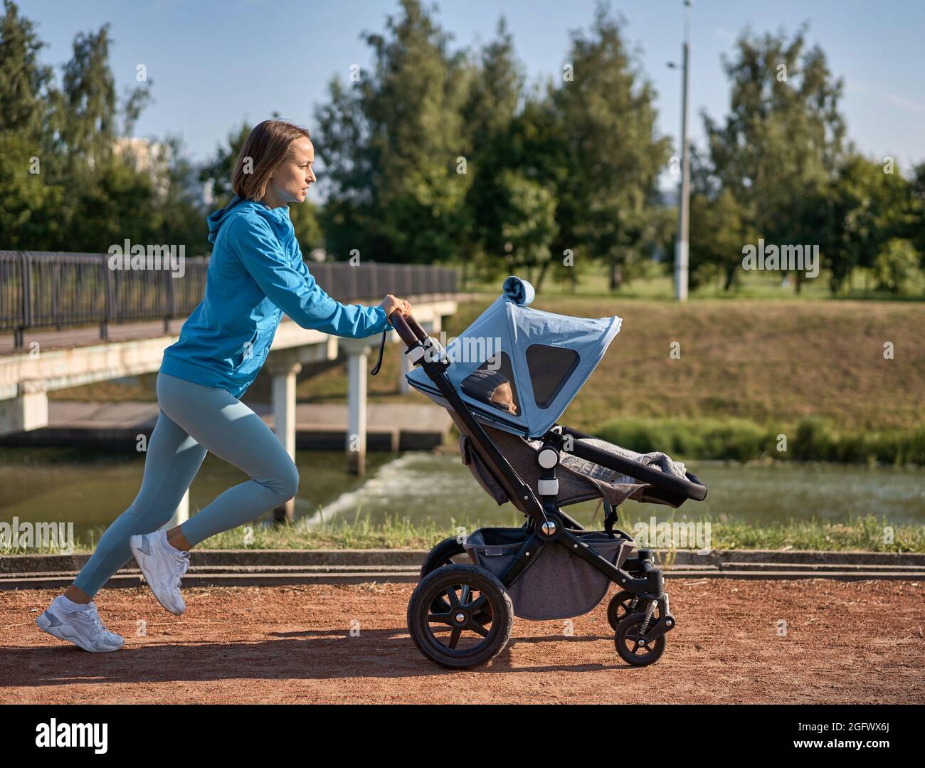 Active mother jogging. Jogging or power walking woman with a baby ...