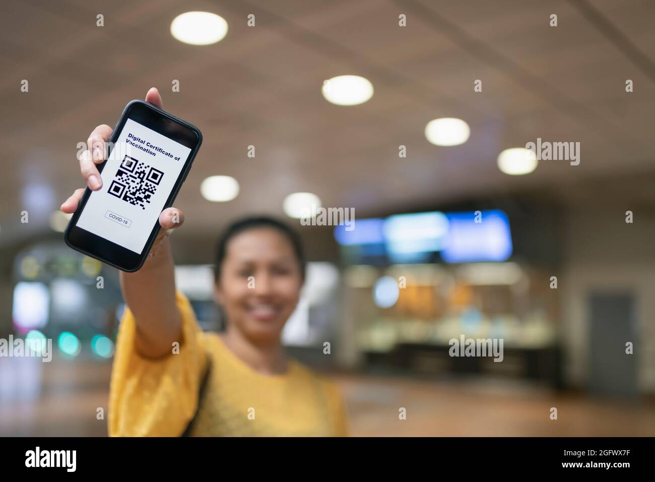 Woman holding phone with QR code Stock Photo - Alamy