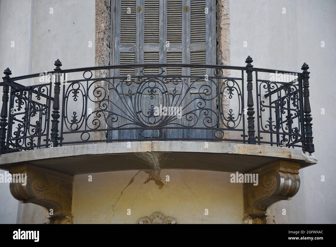 Old Neoclassical house facade with wooden window shutters and a ...