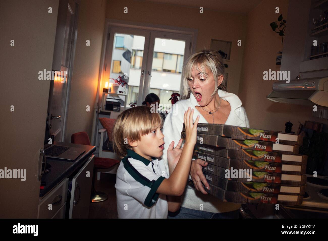 Woman carrying pizza boxes Stock Photo - Alamy