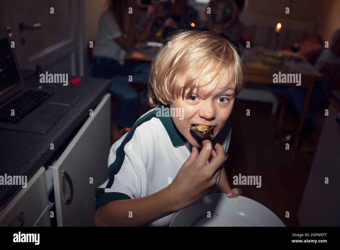 View of boy eating Stock Photo - Alamy